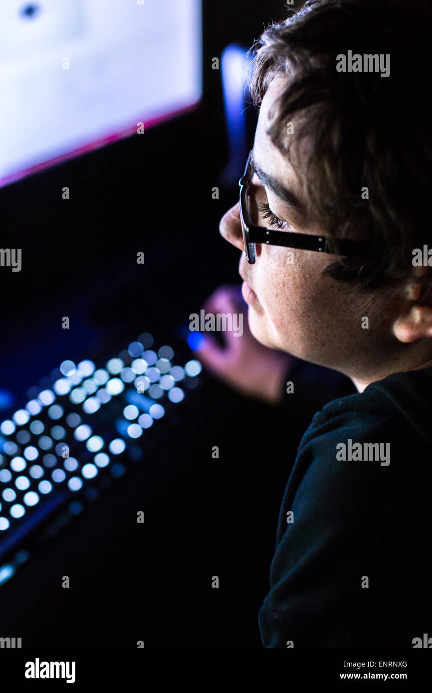 Teenager boy on computer in his room late at night Stock Photo - Alamy