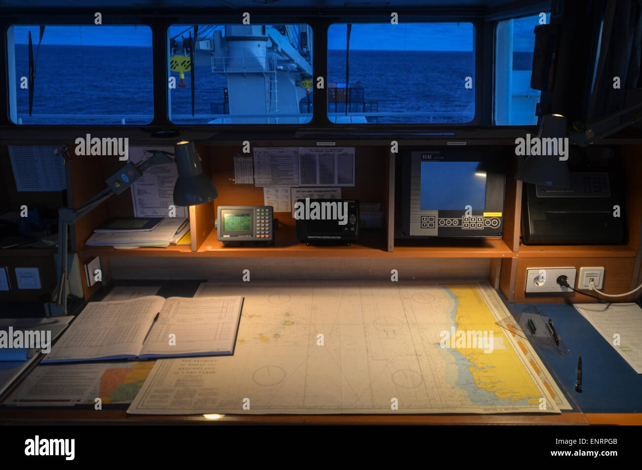 Nautical charts in the ship bridge of a cargo vessel while sailing in ...