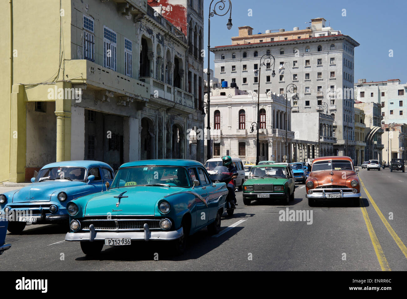 Old American and Russian cars driving along the Malecon, Havana, Cuba ...
