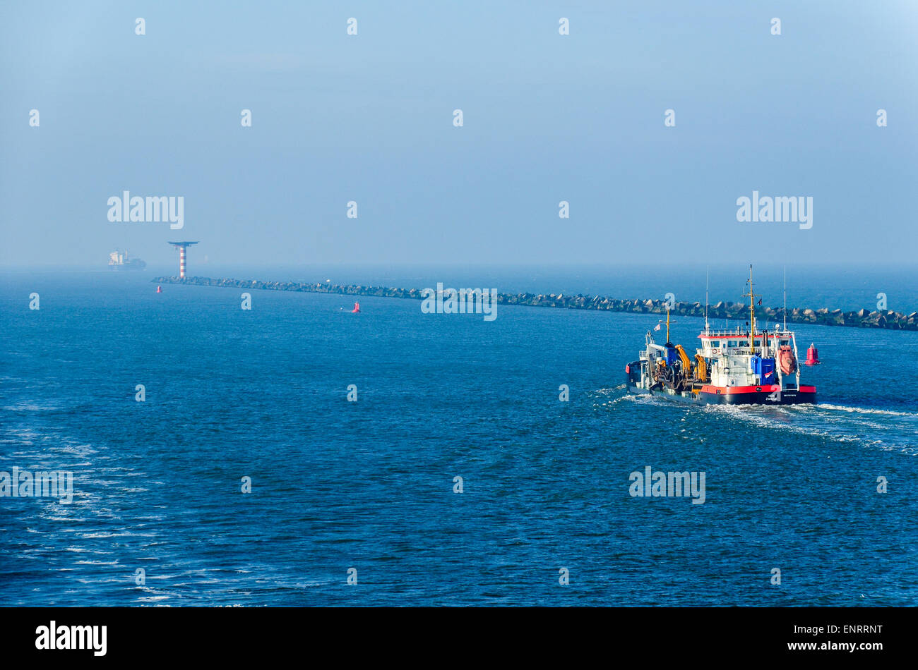 A ship sailing into the open sea from the port of Rotterdam ...