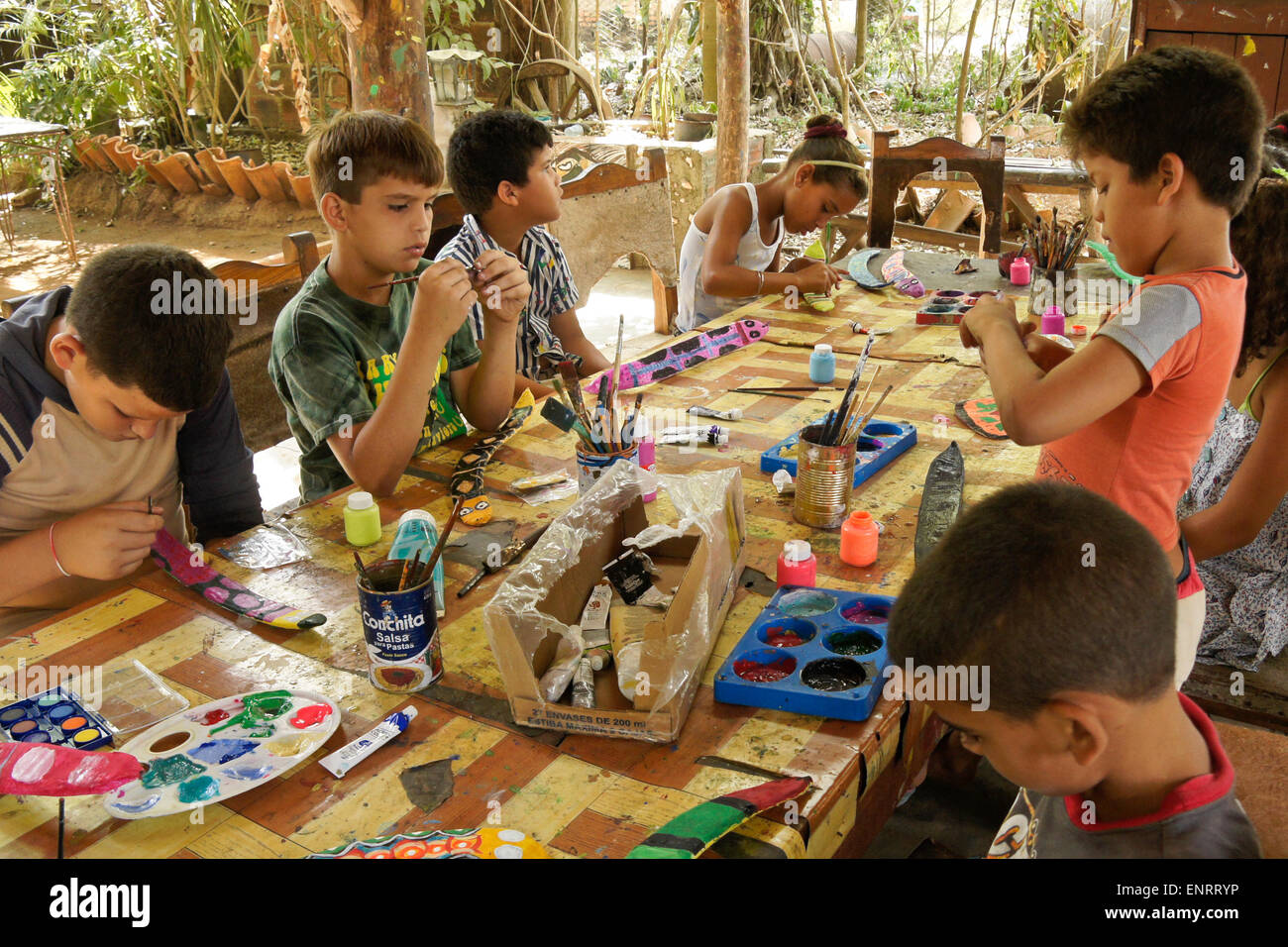 Children decorating seed pods at Mario Pelegrin's community art center ...