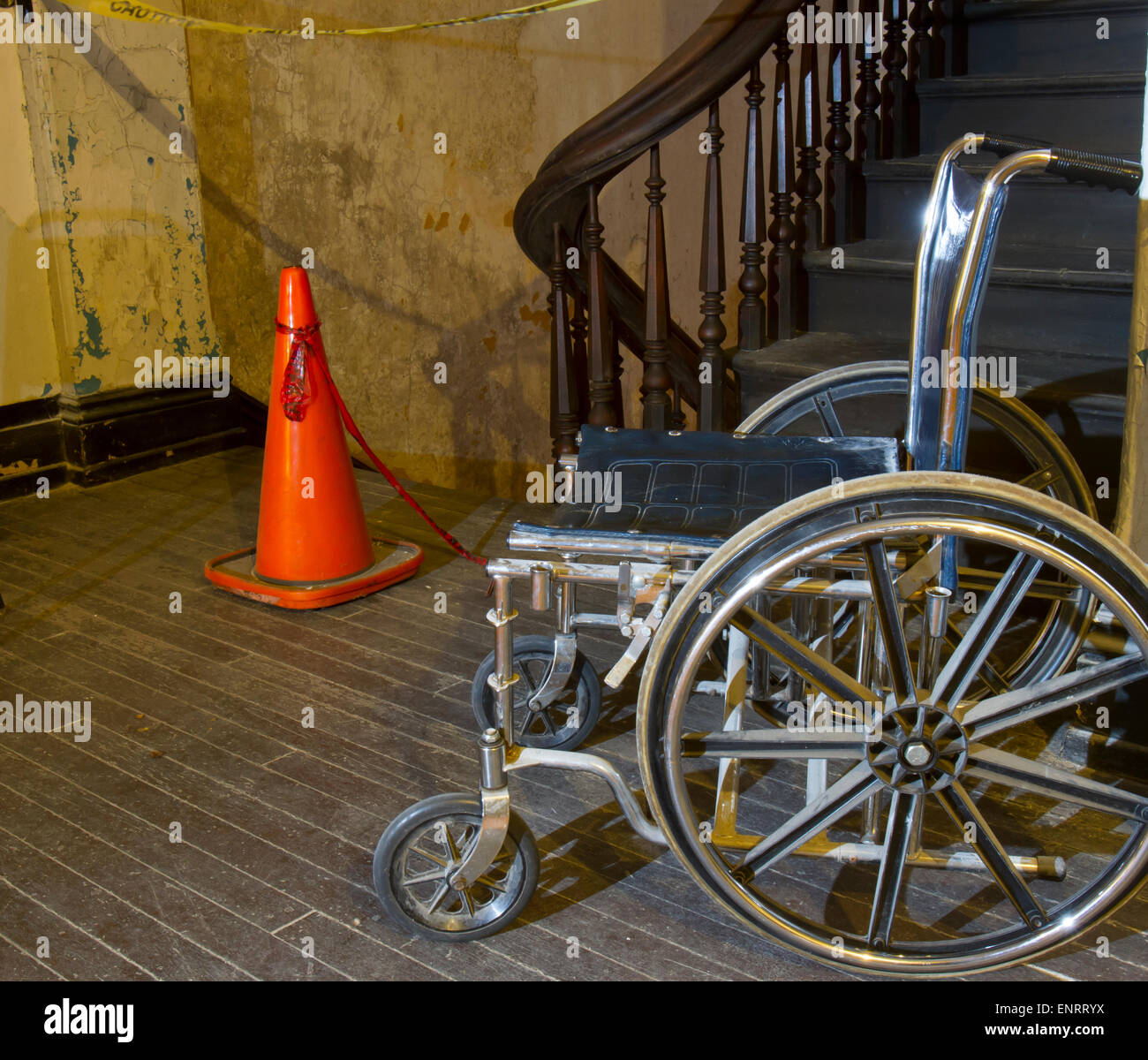 Wheelchair in front of wooden stairs with orange safety cone Stock ...