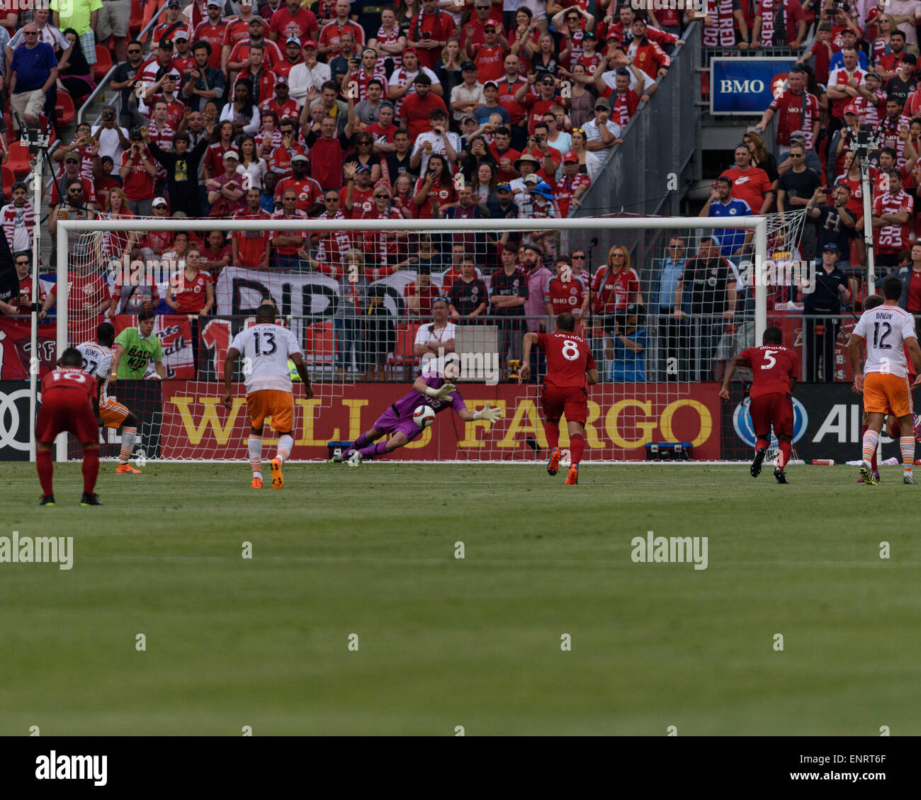 Toronto FC goalkeeper Chris Konopka (1) saves Houston Dynamo midfielder ...