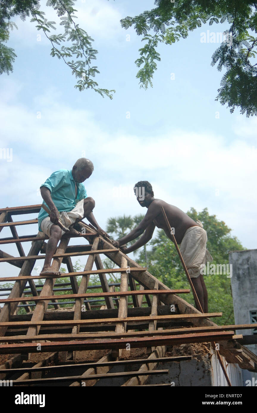 TAMIL NADU, INDIA, circa 2009: Carpenters working on a roof circa 2009 ...