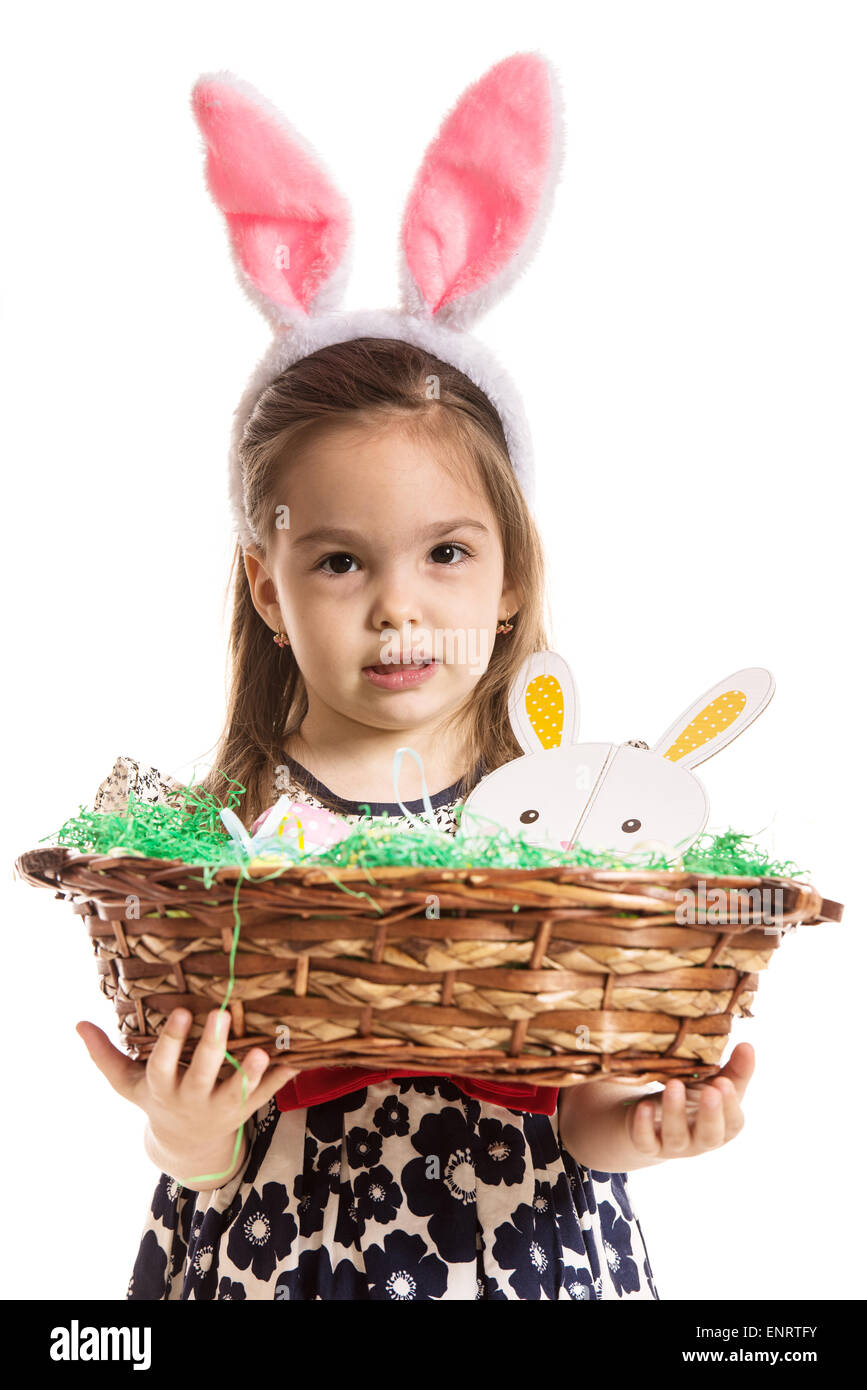 Preschool girl with bunny ears holding basket with easter eggs isolated ...