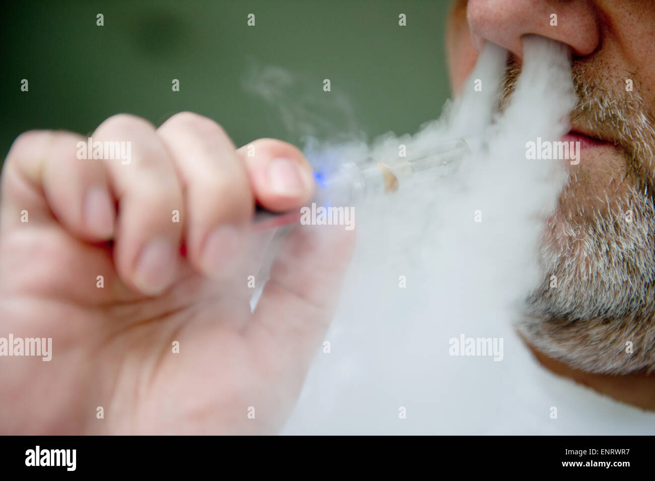 A man smokes a cigarette in Berlin, Germany. Smoking was banned frm ...
