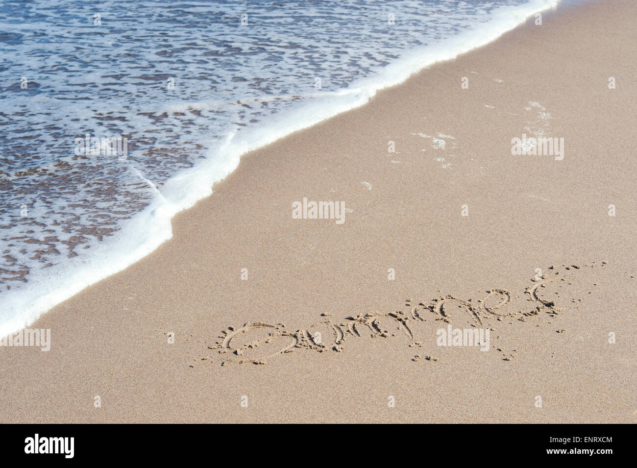 Summer written in the sand on a beach by the sea Stock Photo - Alamy