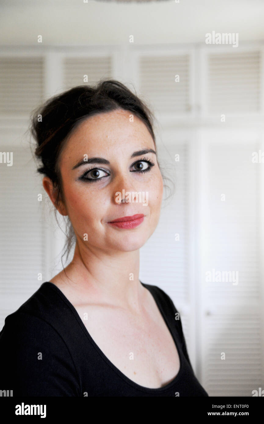 Portrait of beautiful young woman in her 20s dark hair red lipstick ...