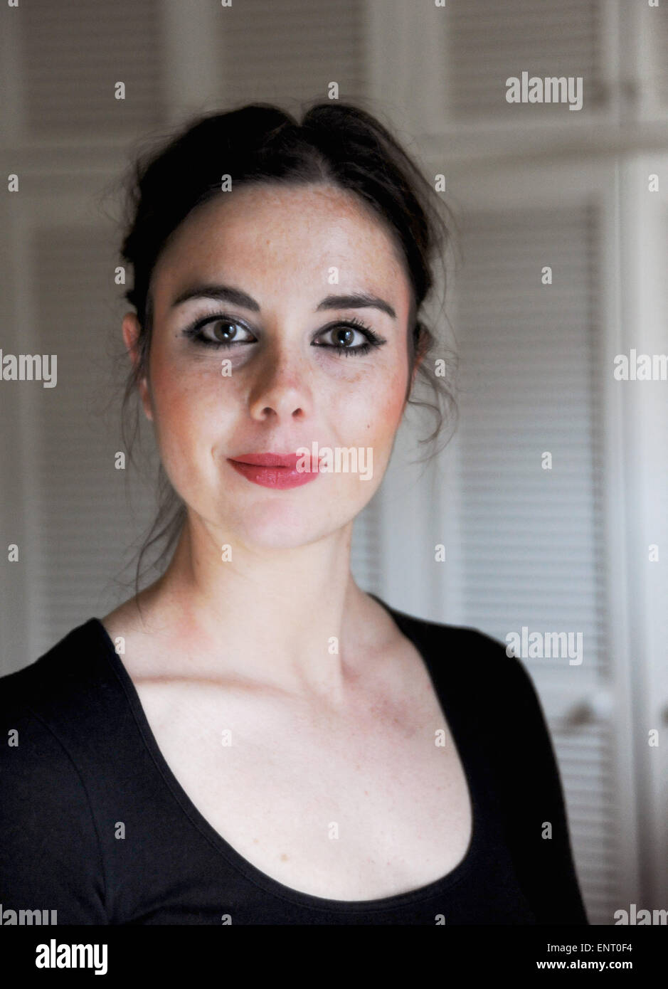 Portrait of beautiful young woman in her 20s dark hair red lipstick ...