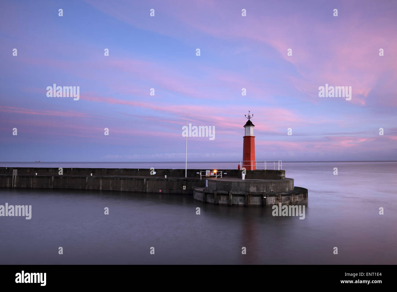 The lighthouse at Watchet, Somerset, at high tide under a colourful ...