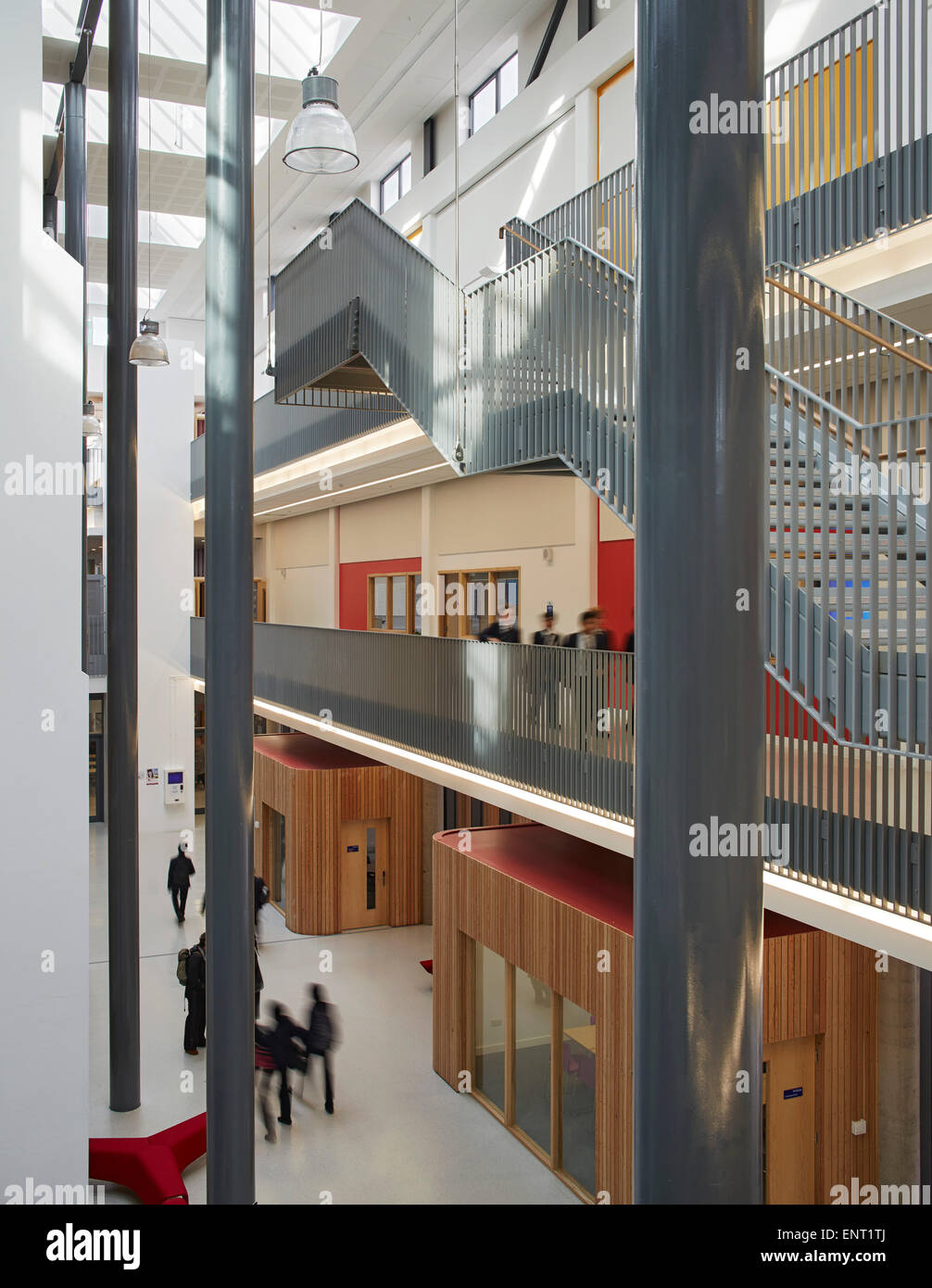 View towards interior stairwell with students in motion. Regent High ...