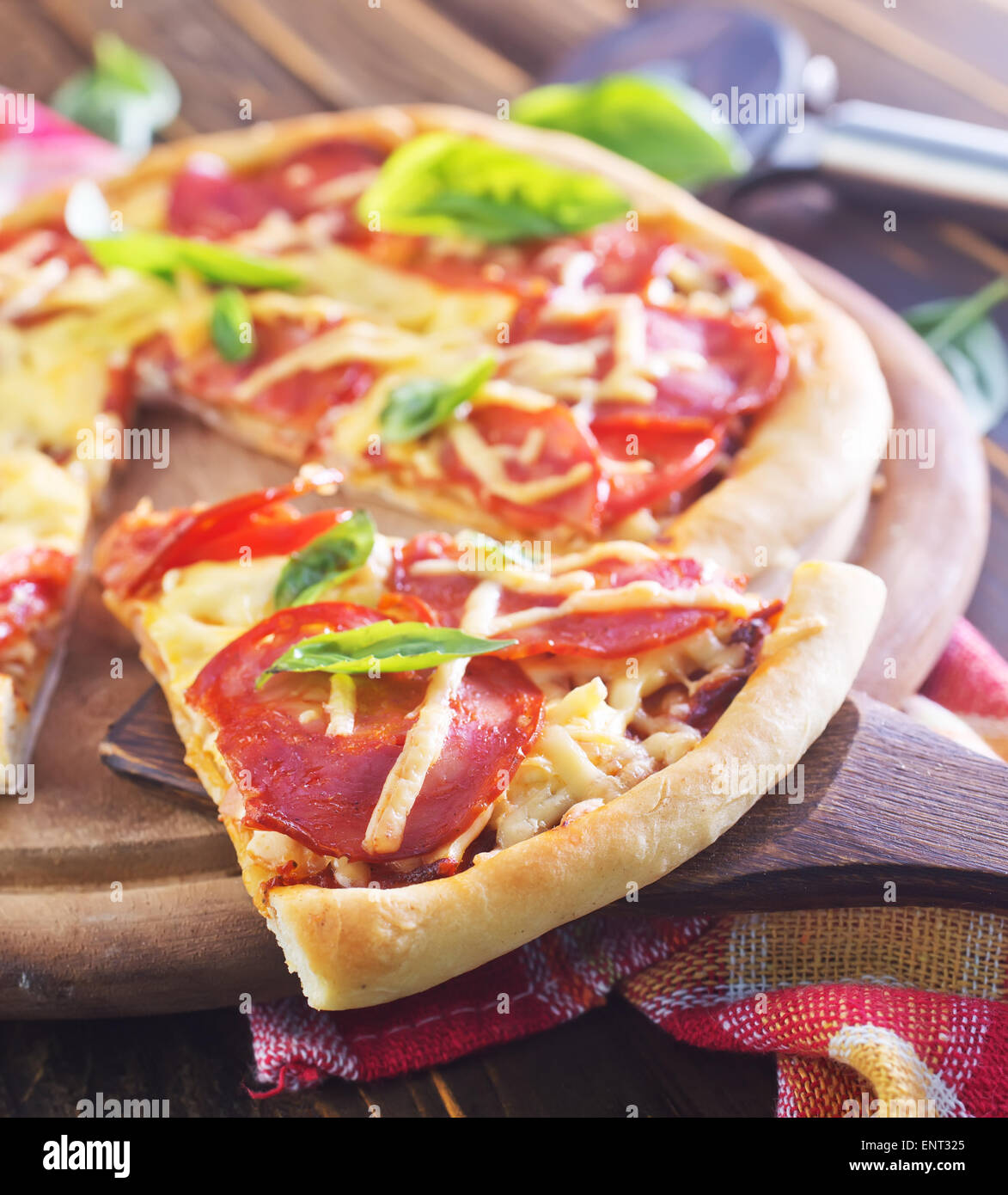 fresh pizza on board and on a table Stock Photo - Alamy