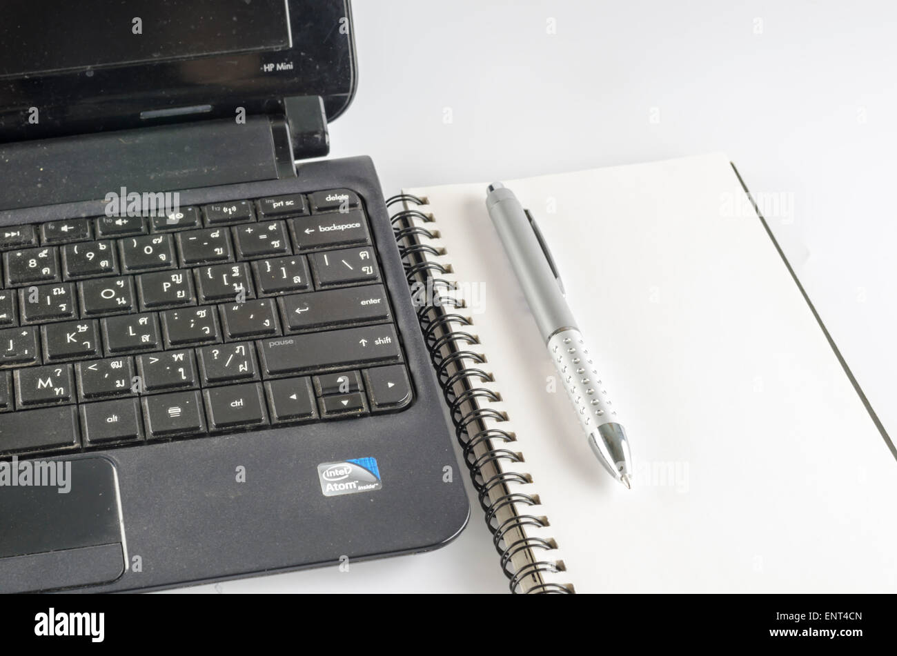notebook with pen and laptop on a white background Stock Photo - Alamy