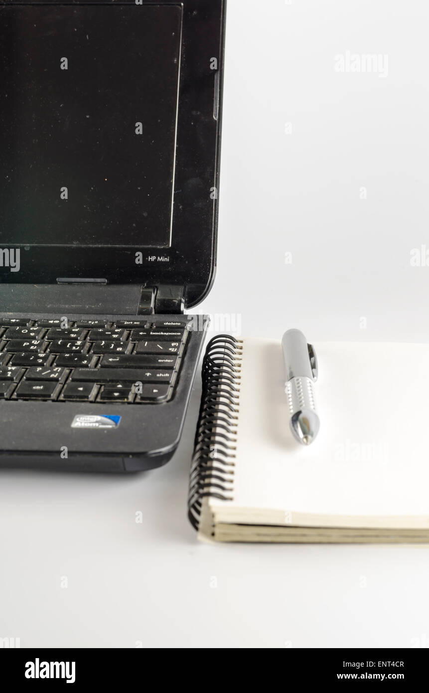 notebook with pen and laptop on a white background Stock Photo - Alamy