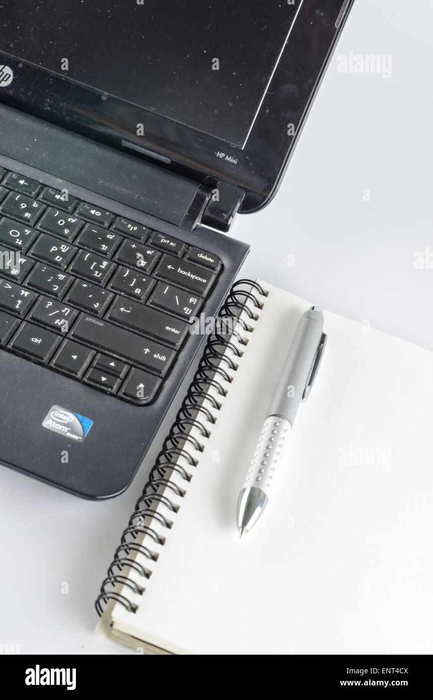 notebook with pen and laptop on a white background Stock Photo - Alamy