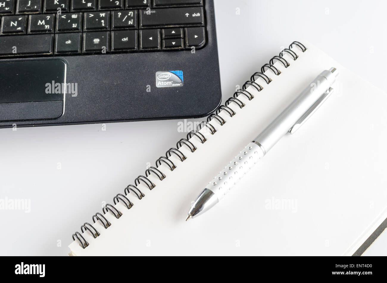 notebook with pen and laptop on a white background Stock Photo - Alamy