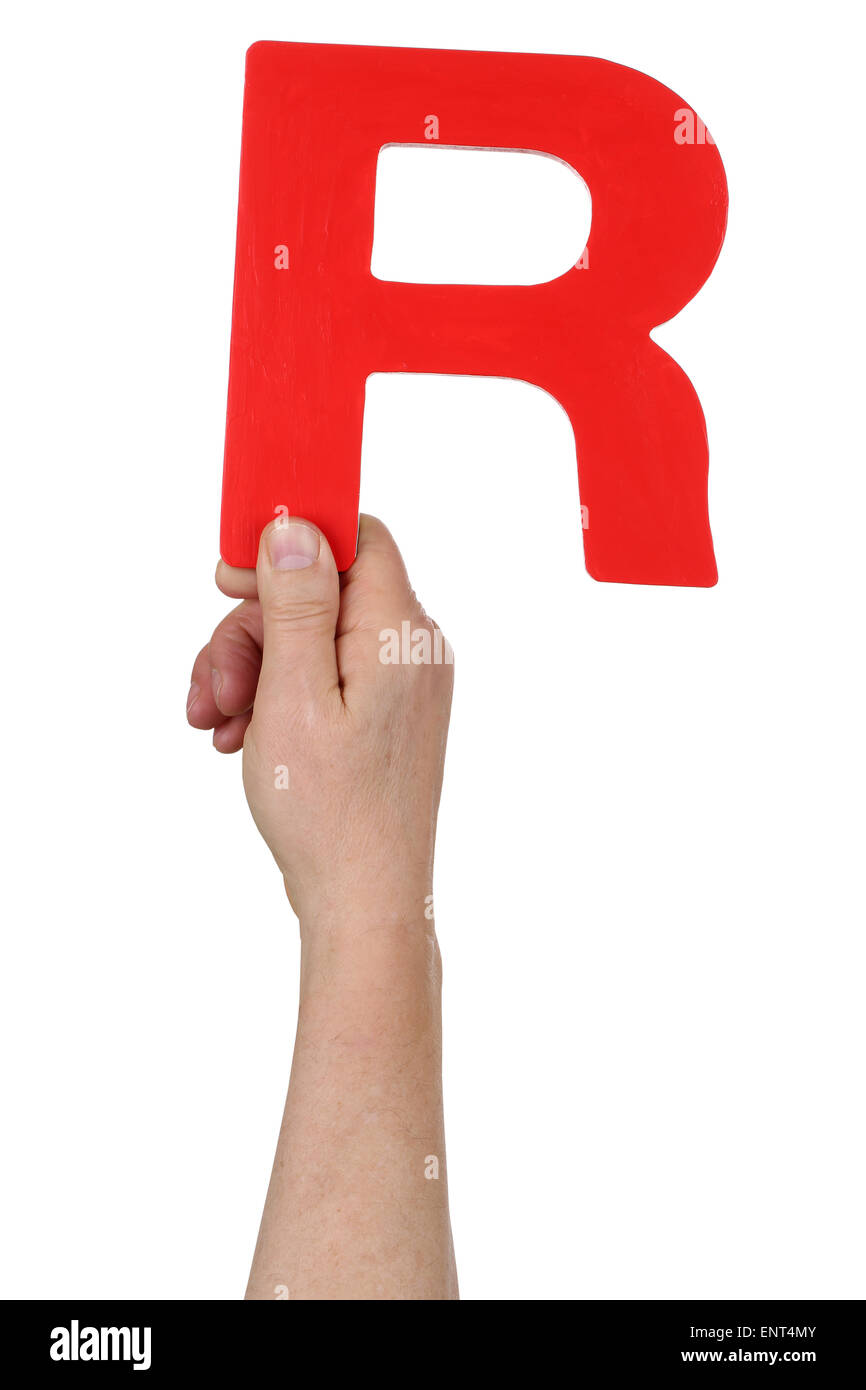 Hand holding letter R from alphabet isolated on a white background ...