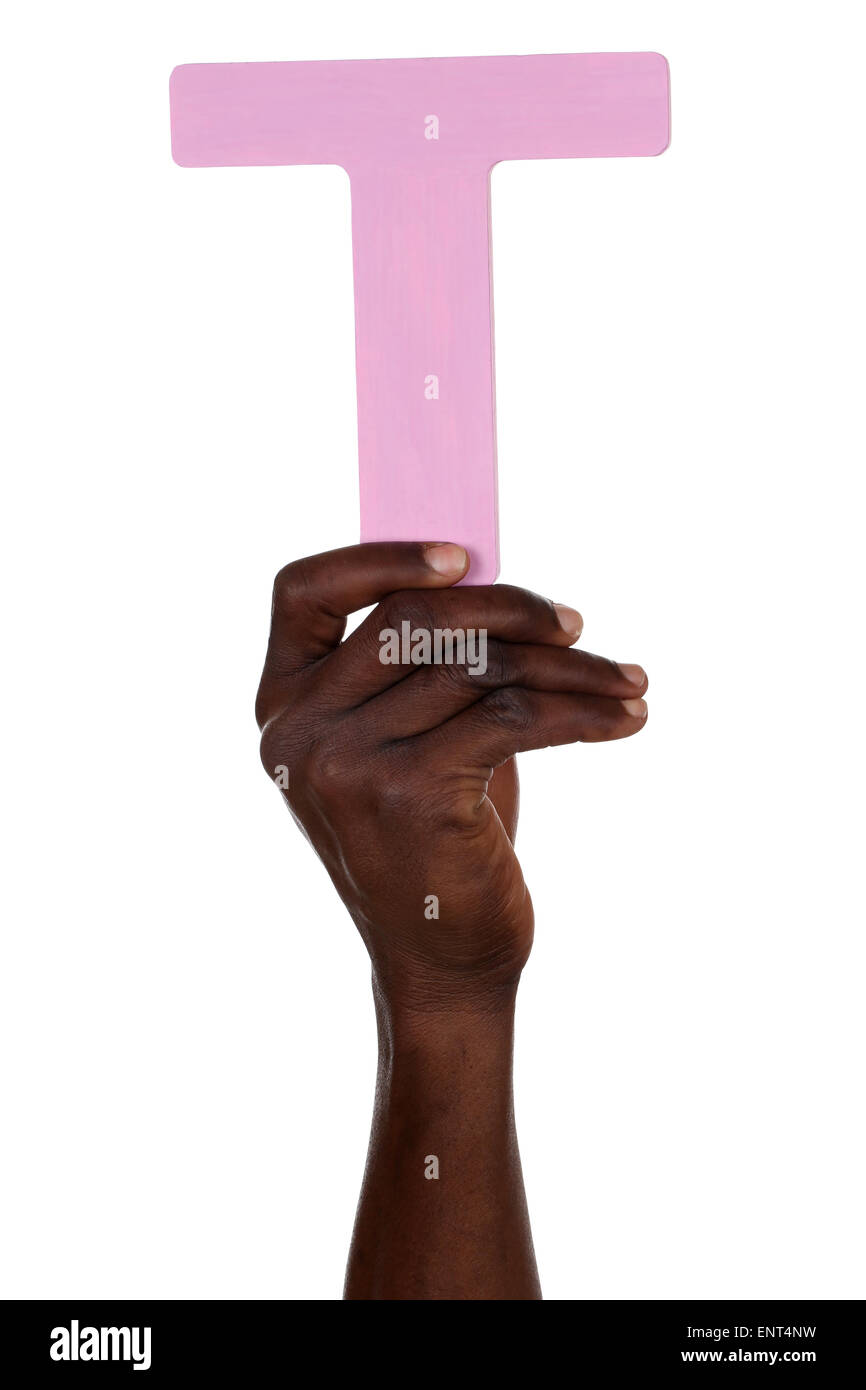 Hand holding letter T from alphabet isolated on a white background ...