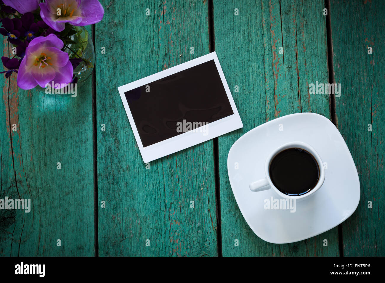 Empty photo card and a cup of coffee on old green wooden board, memory ...