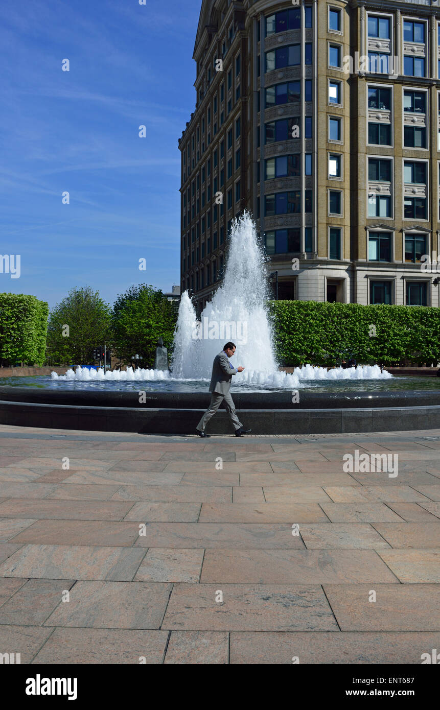 City worker checking mobile phone, Cabot Square, Canary Wharf Estate ...