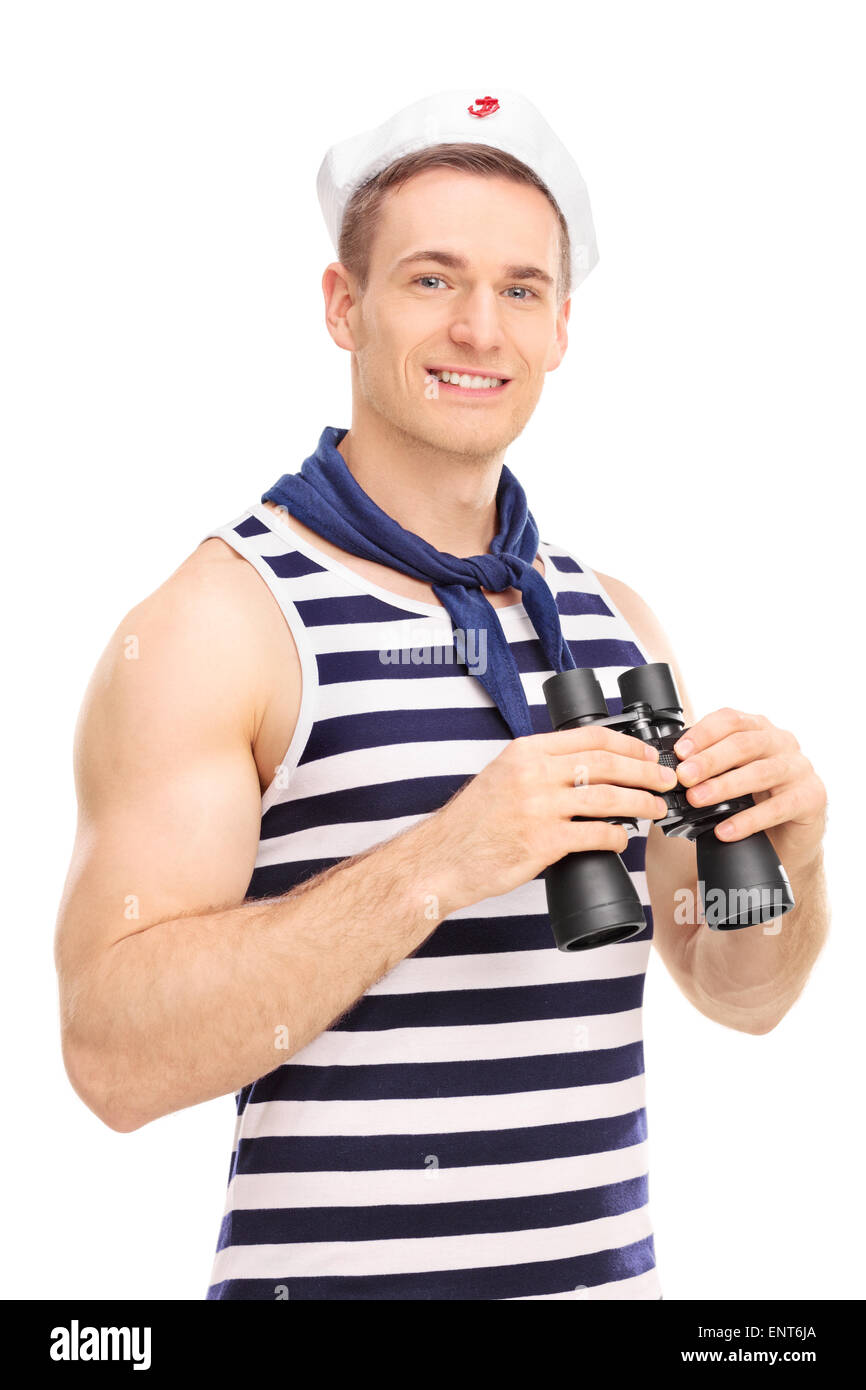 Vertical shot of a male sailor holding binoculars, smiling and looking ...
