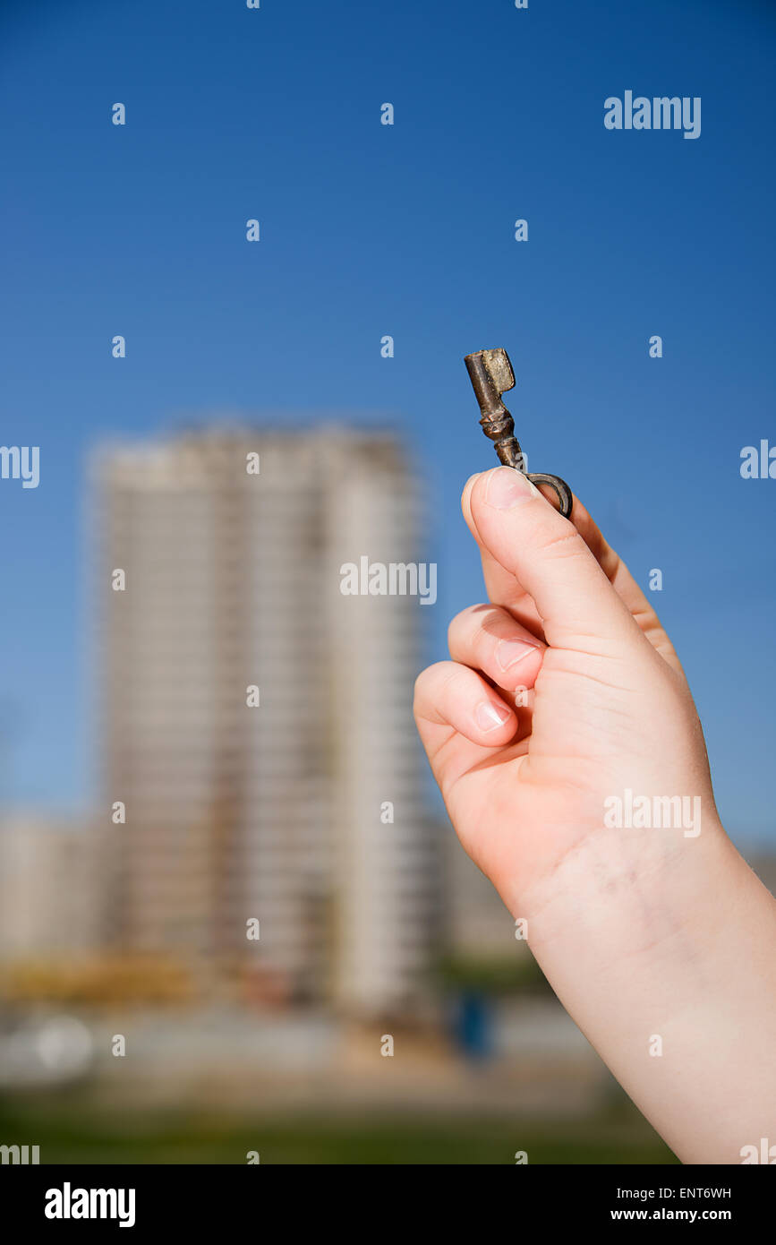 Child hand holding an old key against the sky Stock Photo - Alamy