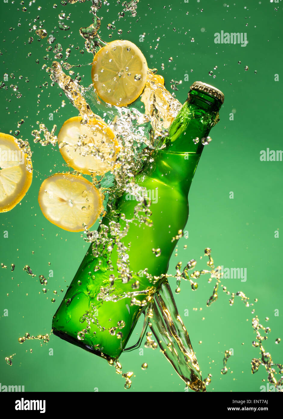 Green beer bottle with splashing liquid, freeze motion Stock Photo - Alamy