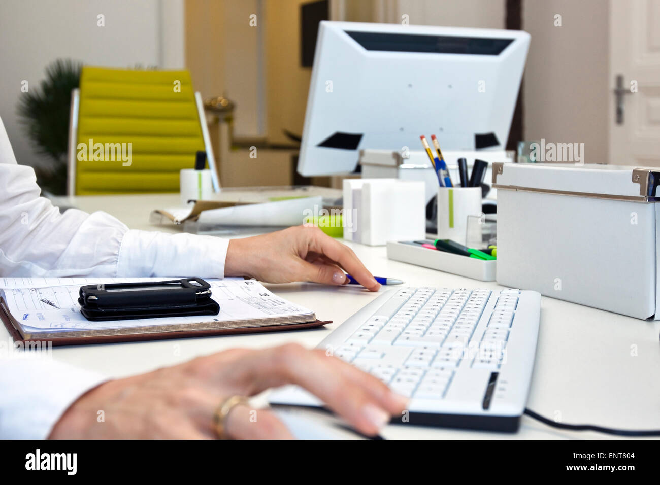 Female hand holding computer mouse and is working at her office desk ...