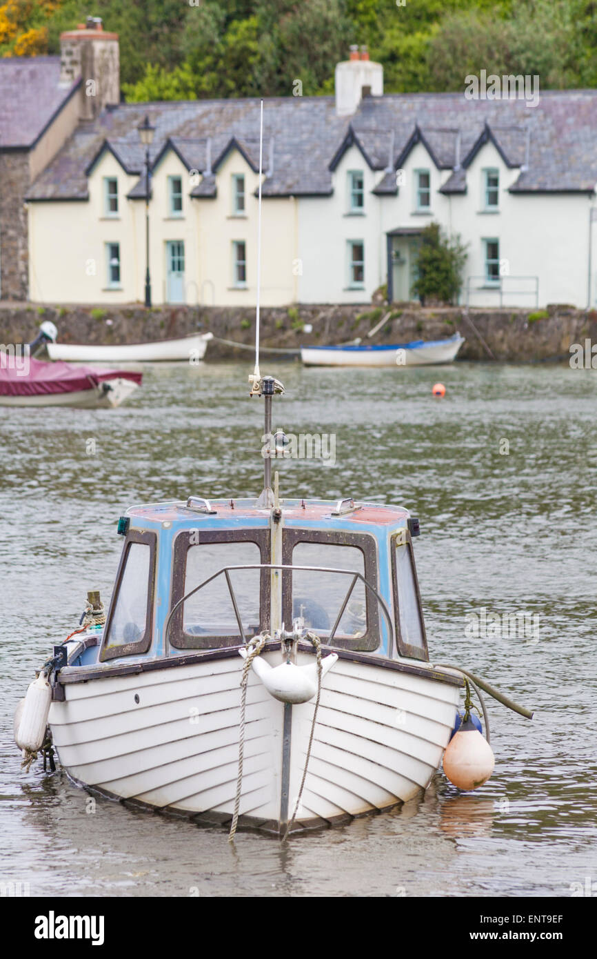 Boat in harbour with cottages in the distance at Lower Fishguard or ...