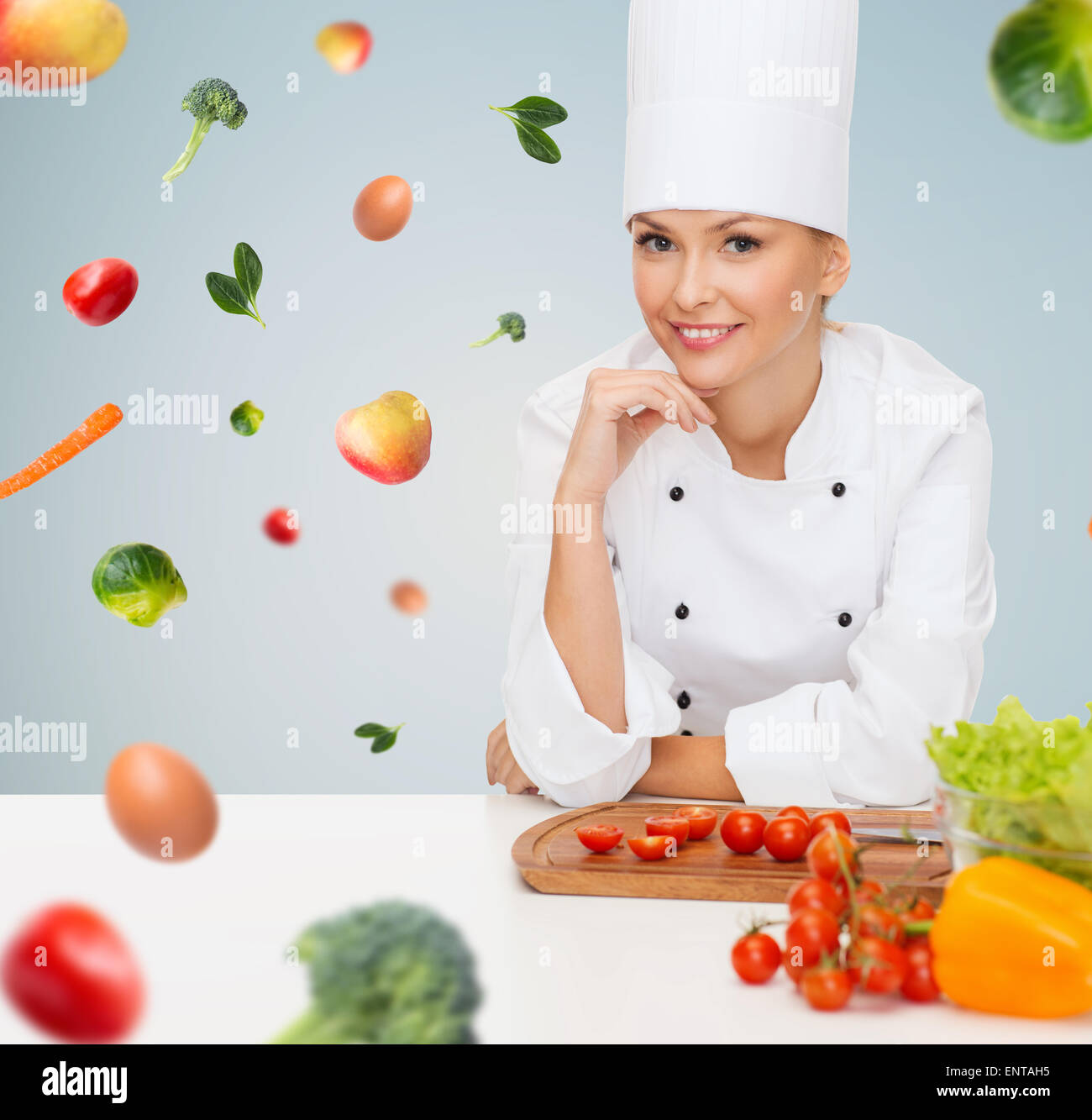 smiling female chef with vegetables Stock Photo - Alamy