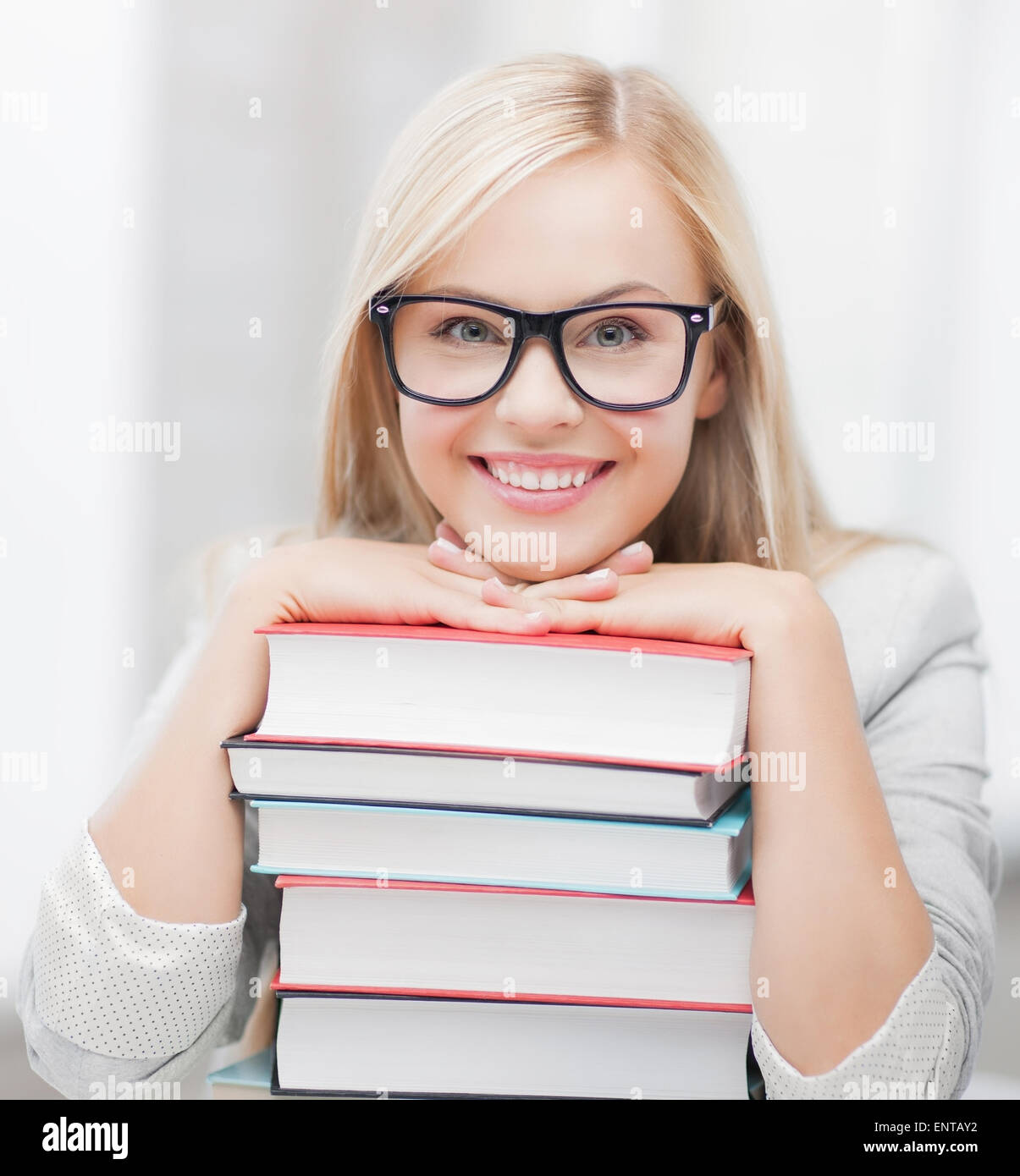 student with stack of books Stock Photo - Alamy