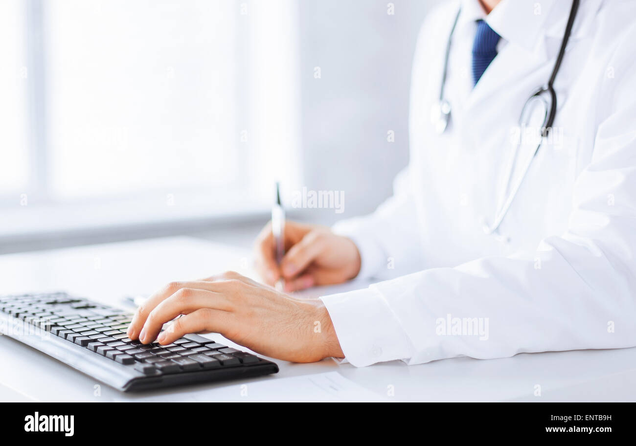male doctor typing on the keyboard Stock Photo - Alamy