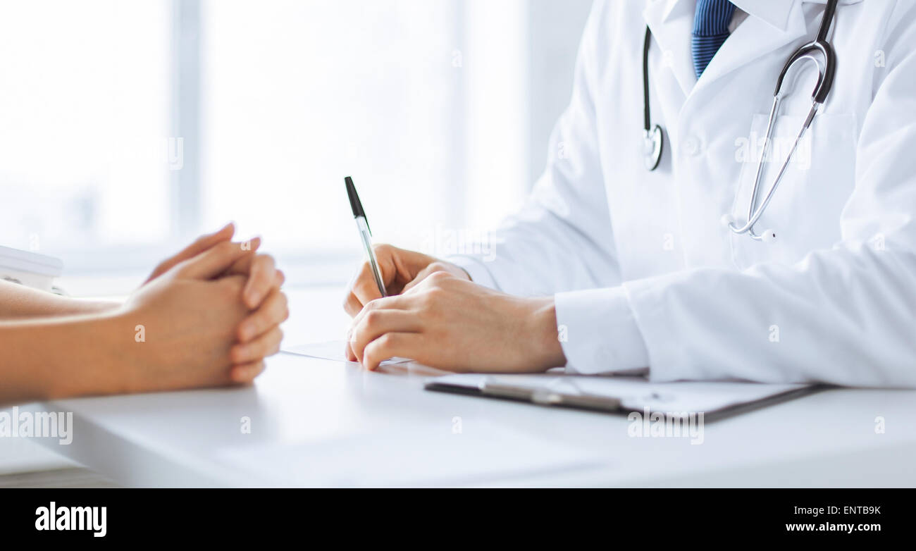 patient and doctor taking notes Stock Photo - Alamy