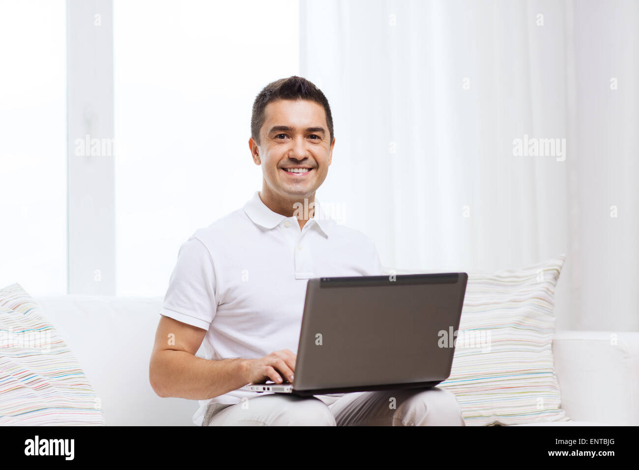 happy man working with laptop computer at home Stock Photo - Alamy