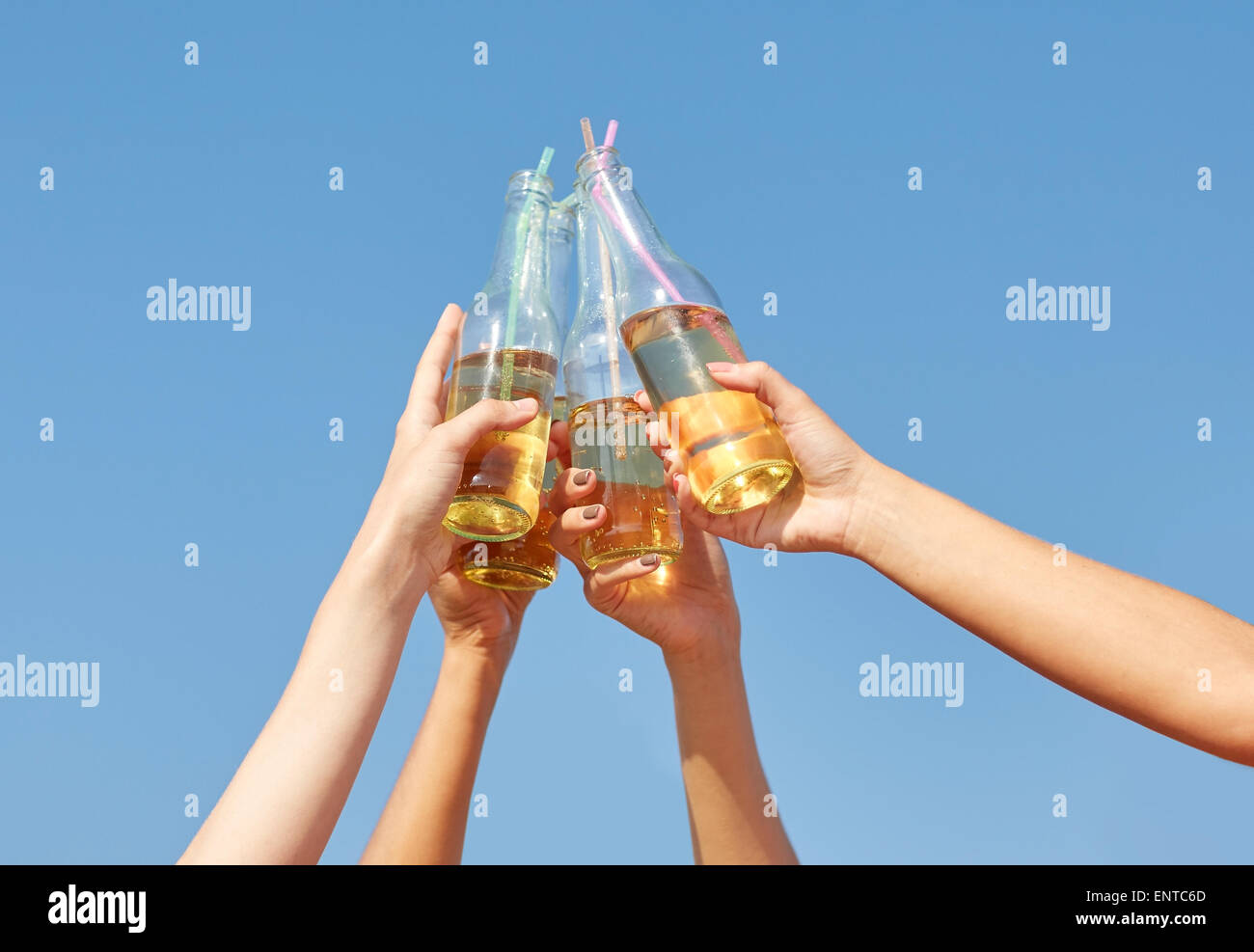 close up of many hands clinking bottles Stock Photo - Alamy