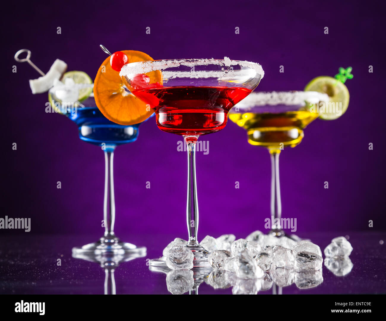 Martini drinks served on glass table with colored dark background Stock ...