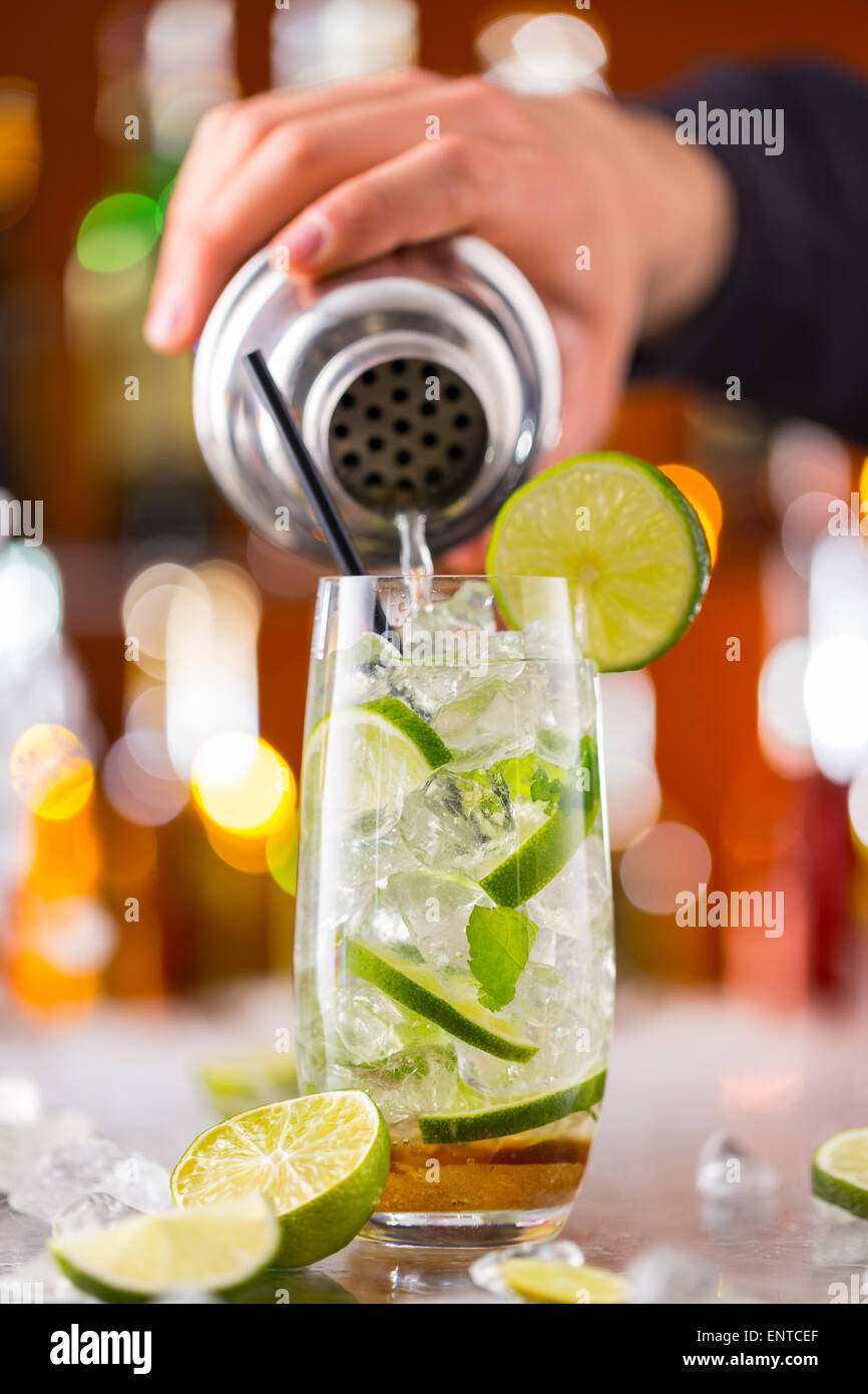 Mojito cocktail drink on bar counter with barman holding shaker Stock ...