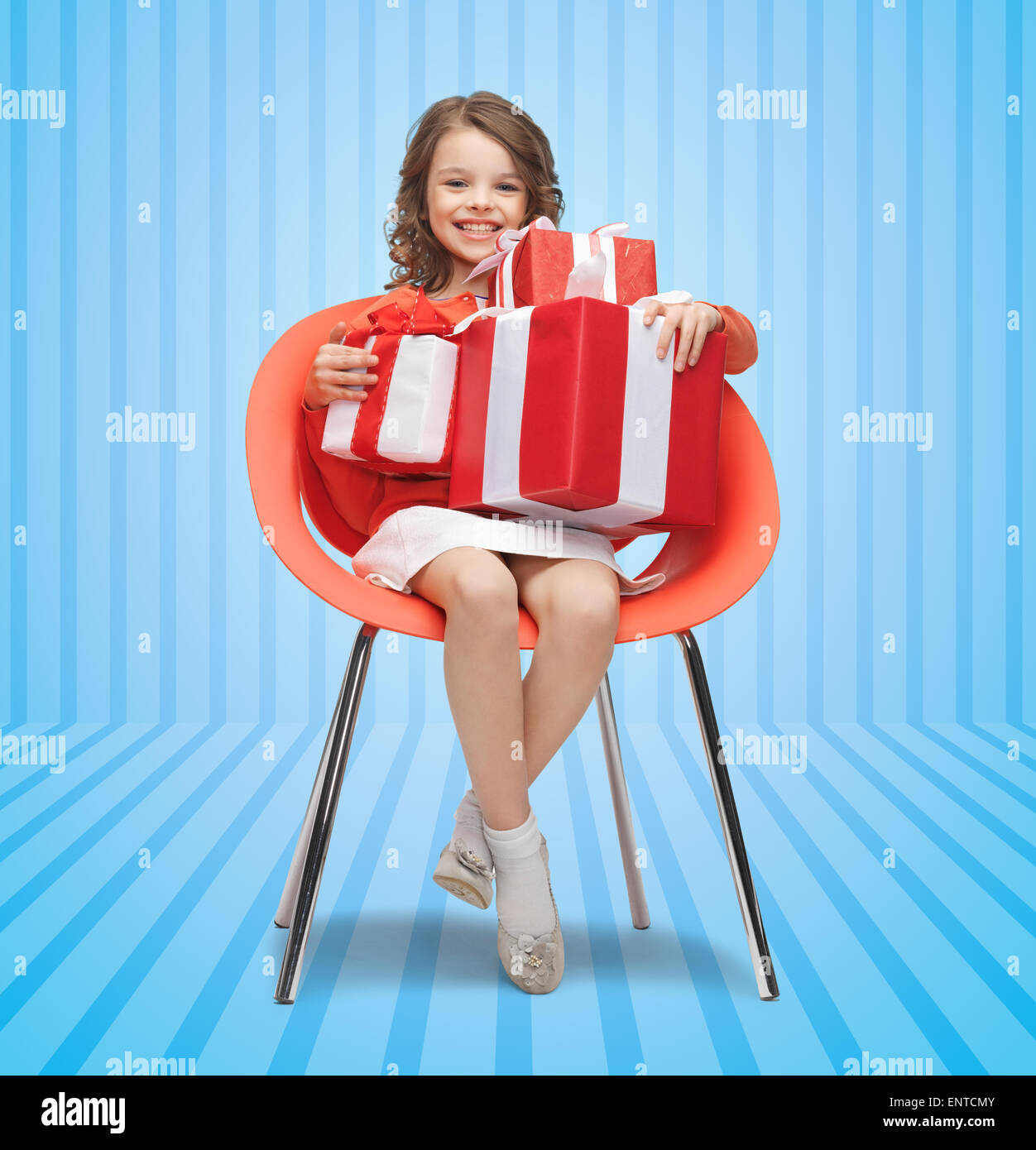 happy little girl with gift boxes sitting on chair Stock Photo - Alamy
