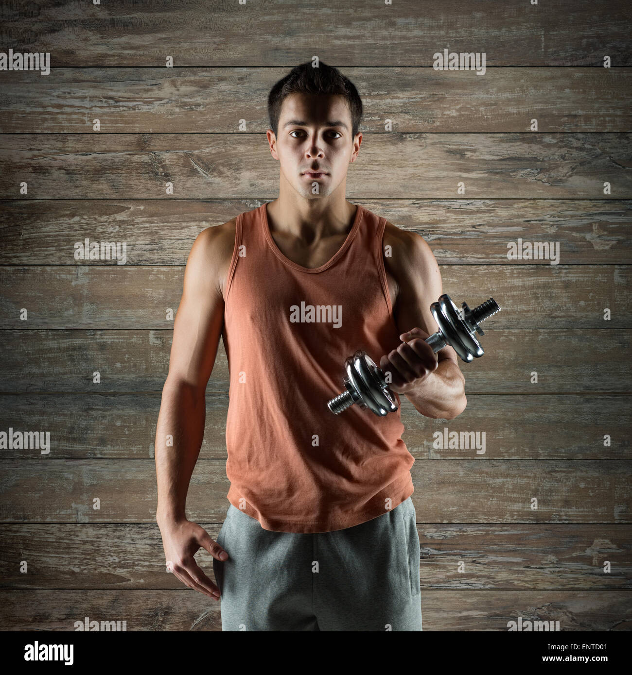young man with dumbbell flexing biceps Stock Photo - Alamy
