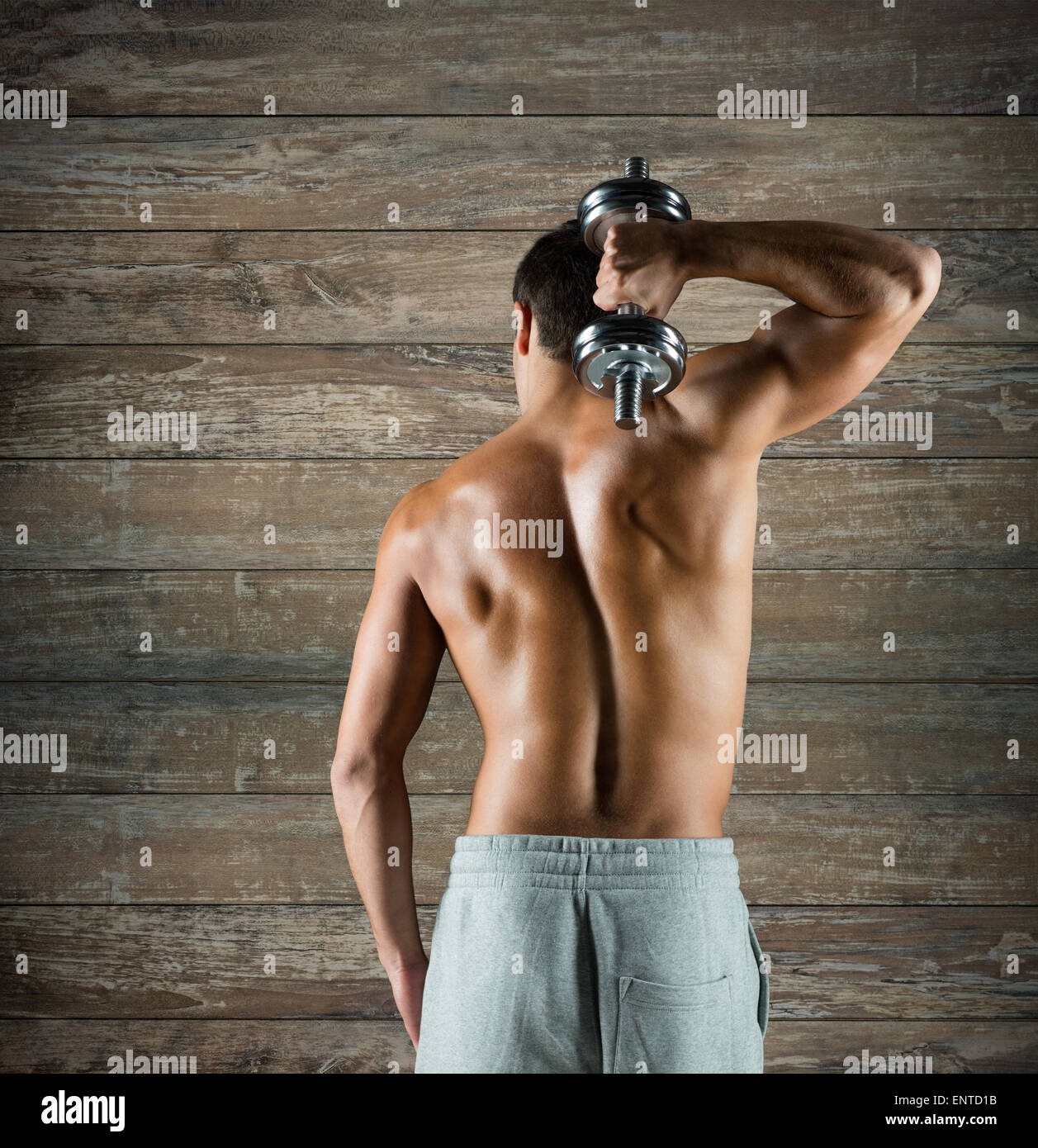 young man with dumbbell flexing biceps Stock Photo - Alamy