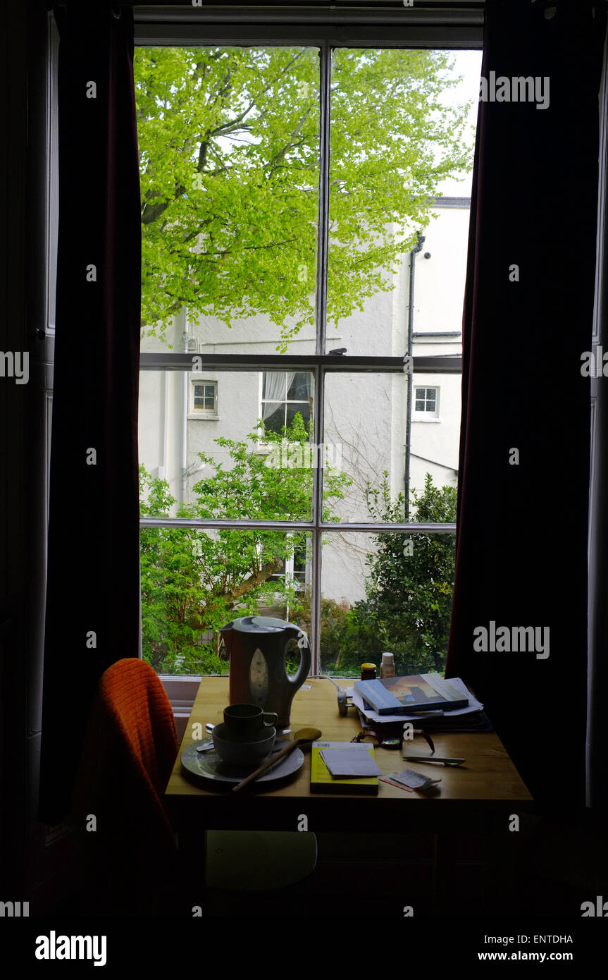 A small table by a window looking out onto a back garden in the Clifton ...