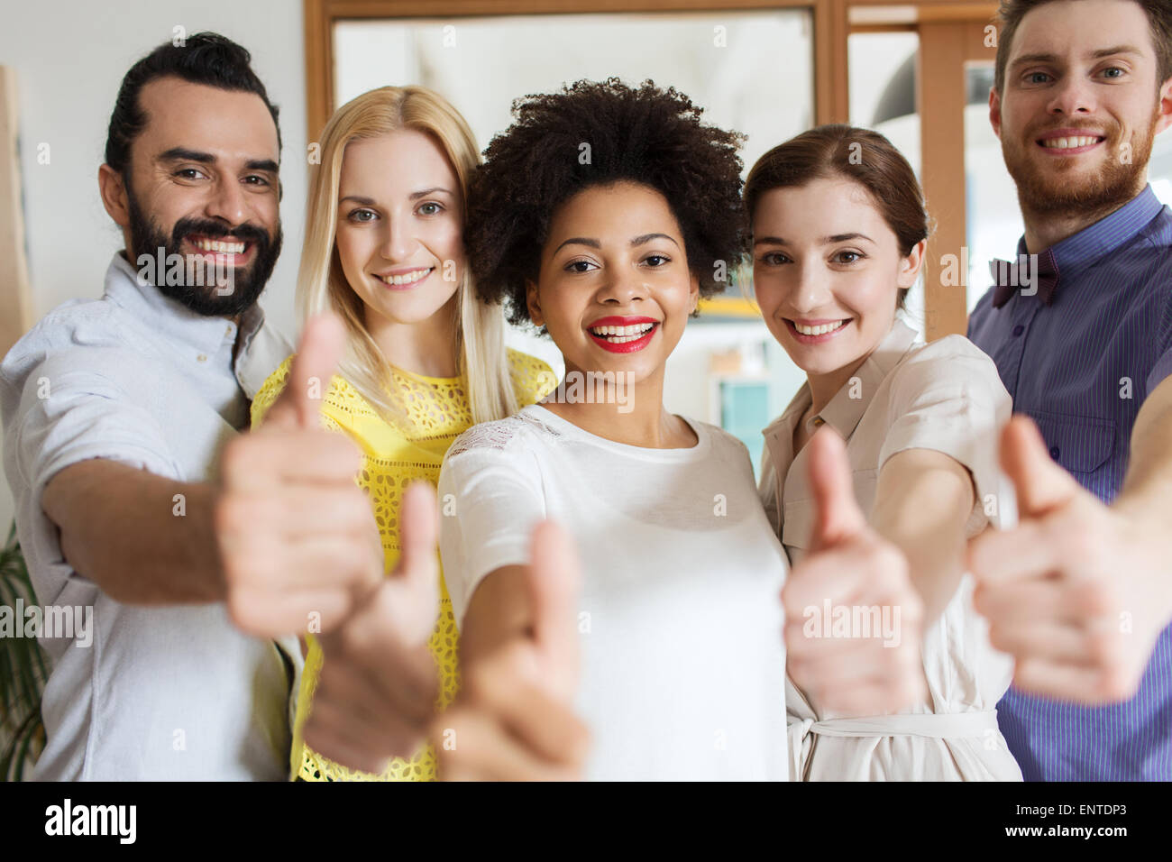 Team creative designers showing thumbs hi-res stock photography and ...