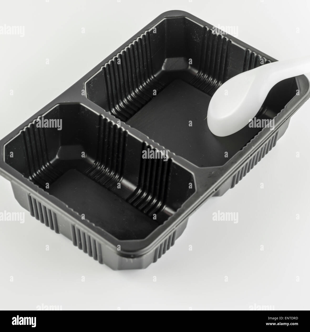 empty black plastic tray and spoon on a white background Stock Photo ...