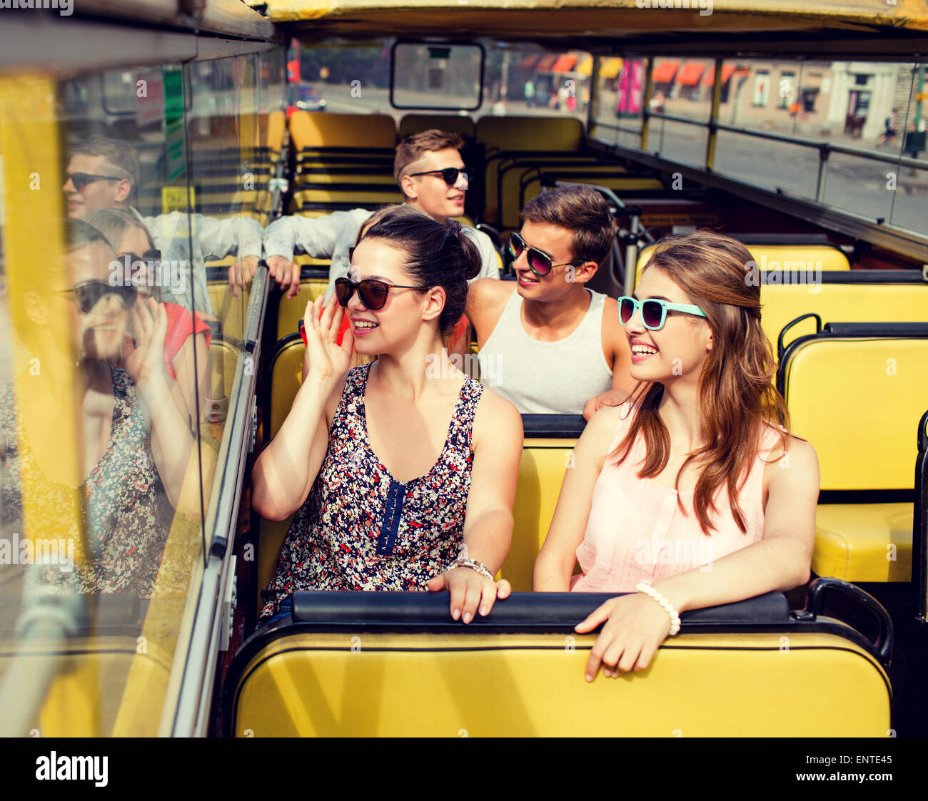 group of smiling friends traveling by tour bus Stock Photo - Alamy
