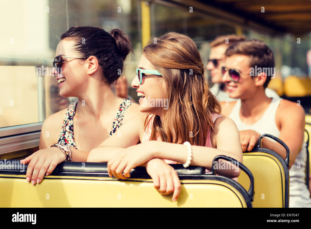 group of smiling friends traveling by tour bus Stock Photo - Alamy