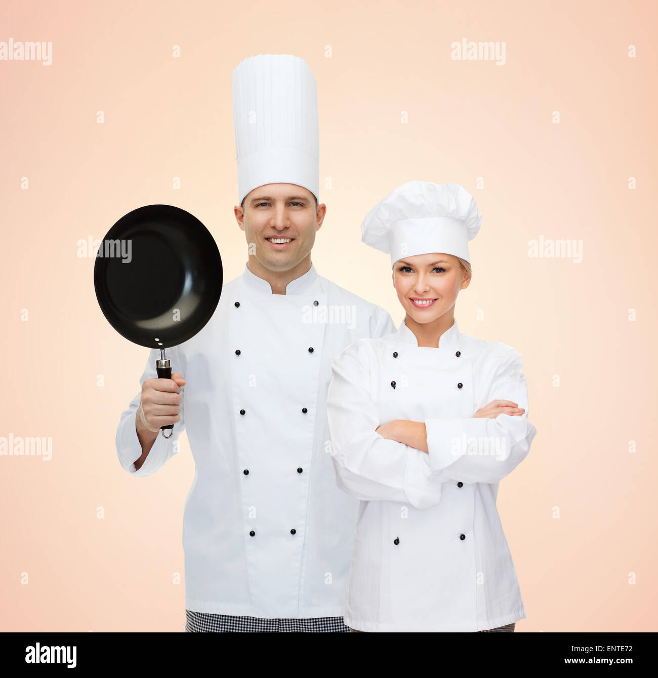 happy chefs or cooks couple with frying pan Stock Photo - Alamy