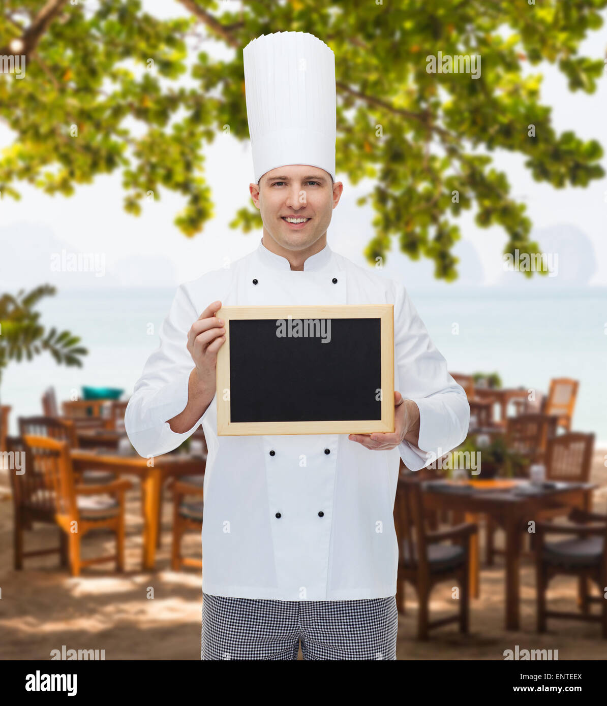 happy male chef cook holding blank menu board Stock Photo - Alamy