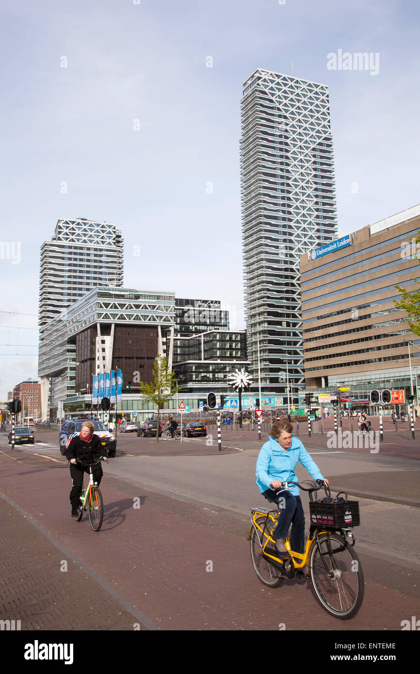 people on bicycle in front of hatel and apartment building new babylon ...