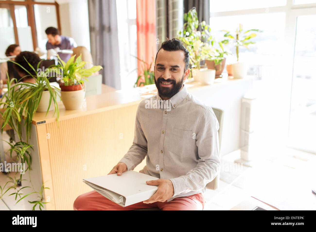 happy creative male office worker with folfer Stock Photo - Alamy