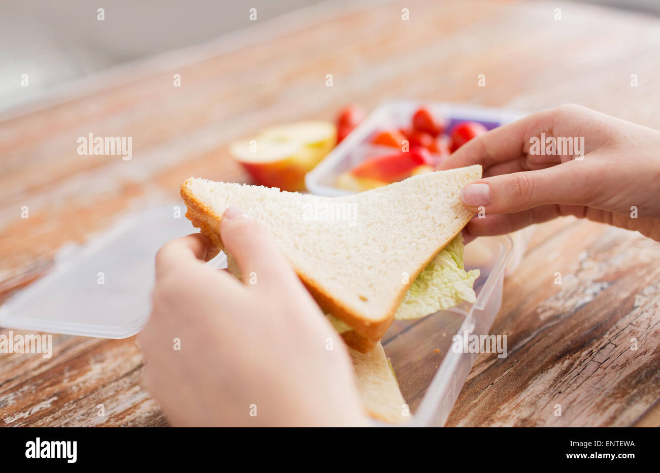close up of woman with food in plastic container Stock Photo - Alamy
